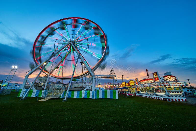 Blurred Ferris Wheel at American Summer County Fair during Dusk ...