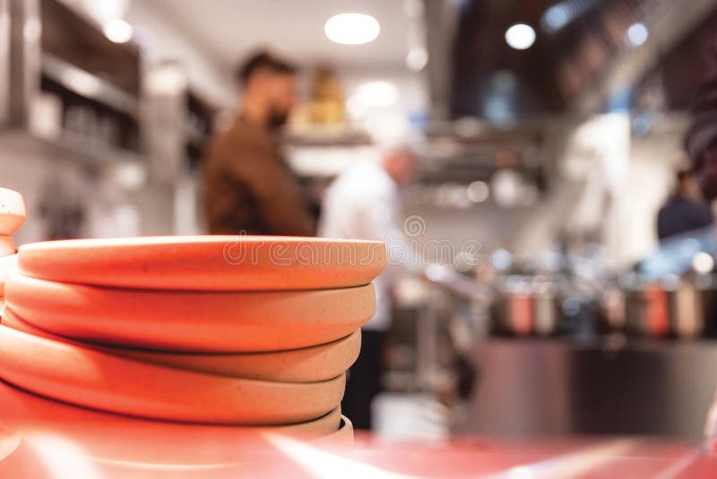 Blurred Head Chef of a Restaurant Kitchen Cooking, Plates in the Focus ...