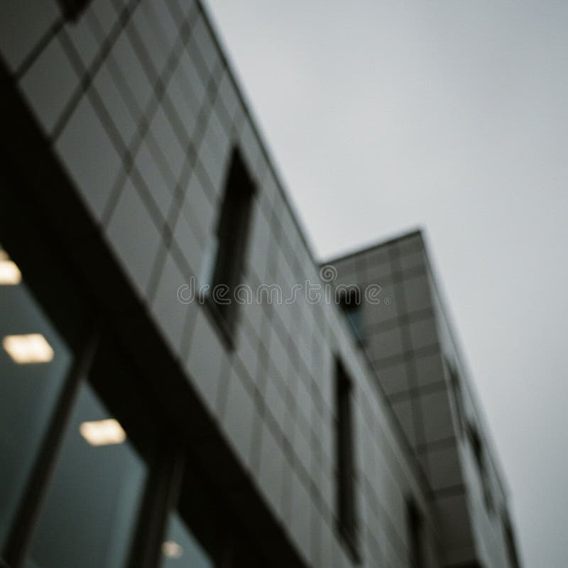 Blurred Image Featuring a Modern Building Facade with a Grid-like ...