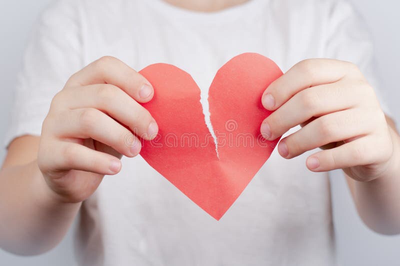 Blurred Image of Hands Tearing a Paper Heart on a Light Background ...