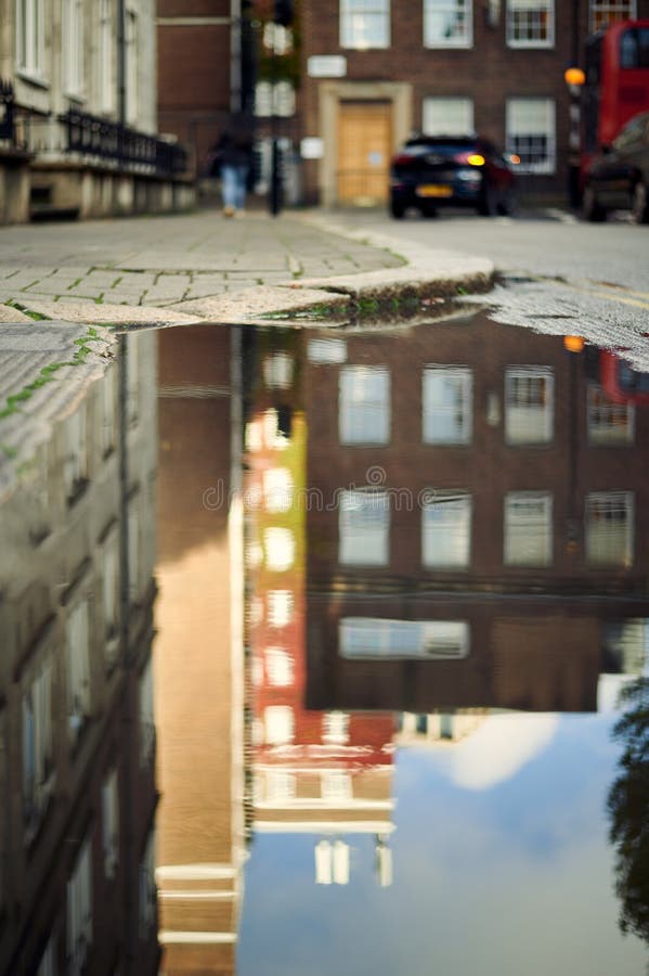 Blurred Image of London Street and Buildings in Reflection of Puddle of ...