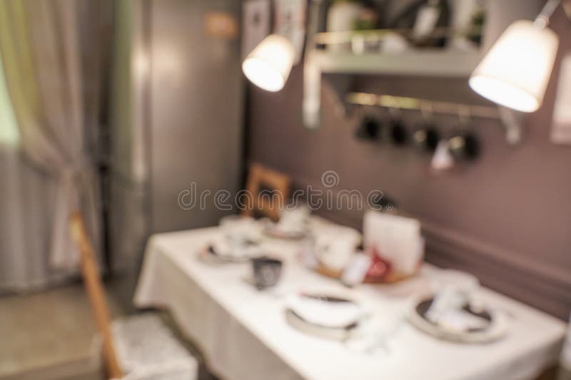 Blurred Kitchen Interior with Dining Table Setting and Soft Ambient ...
