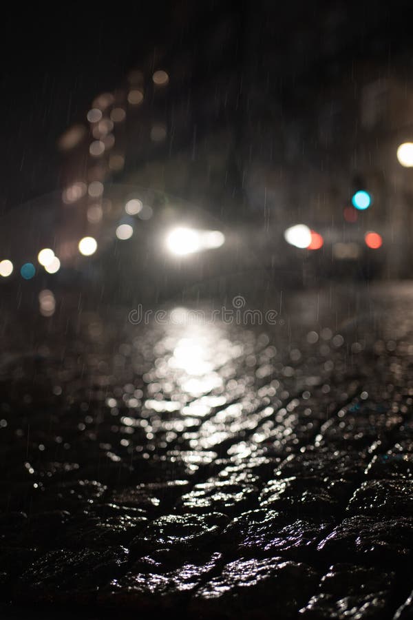 Blurred Low Angle View of Car Headlights Shining in Rain with ...