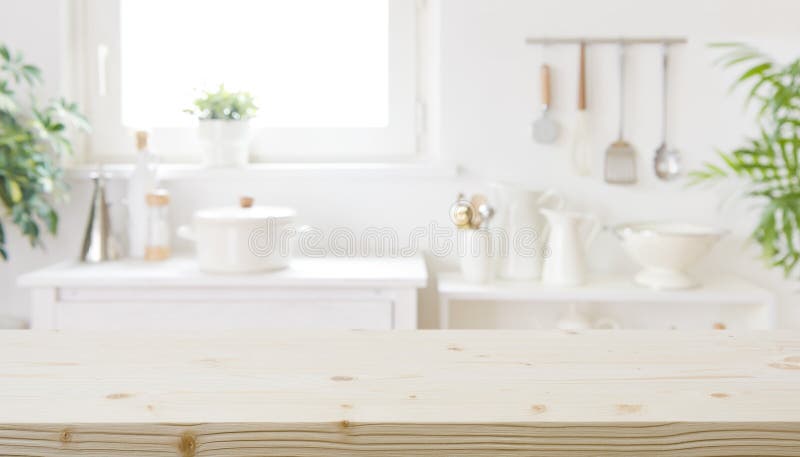 Blurred Modern Kitchen Furniture Interior with Wooden Table in Front ...