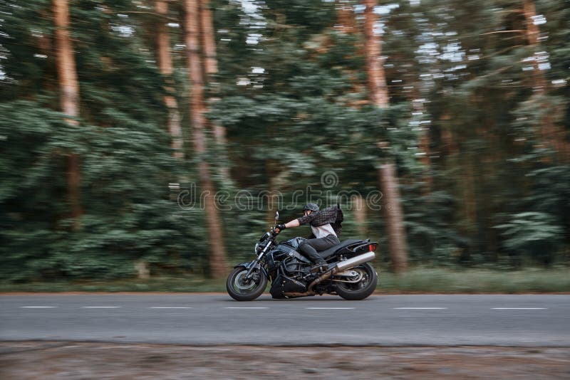 Blurred Motion a Young Man Biker in a Helmet Quickly Rides at High ...