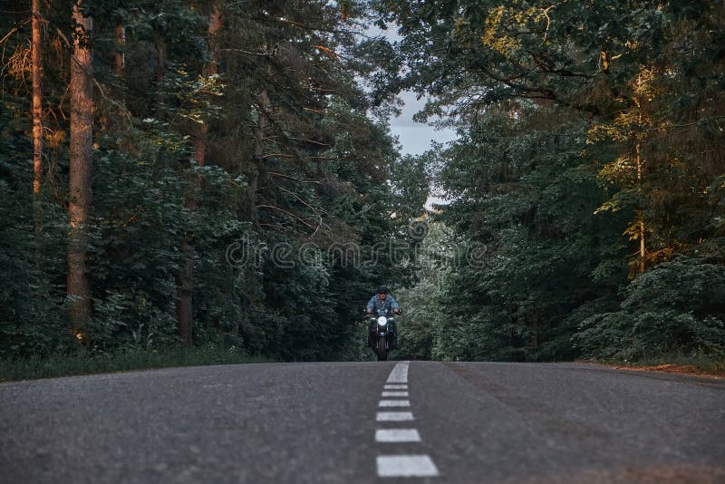 Blurred Motion a Young Man Biker in a Helmet Quickly Rides at High ...