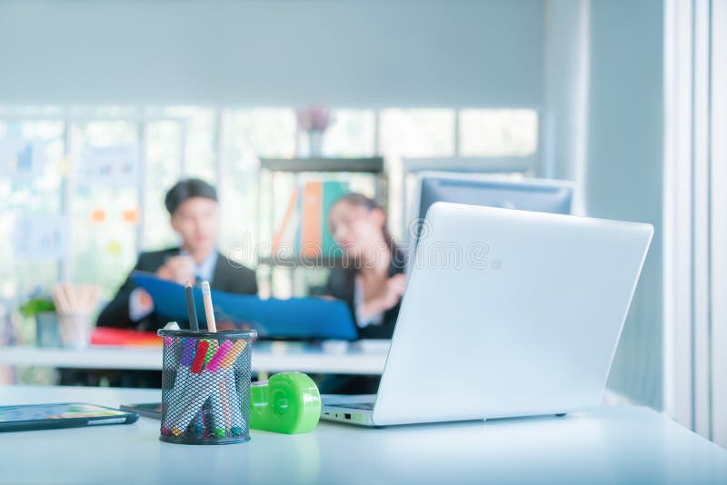 Blurred Office Workers Working in Background with Office Desk and ...
