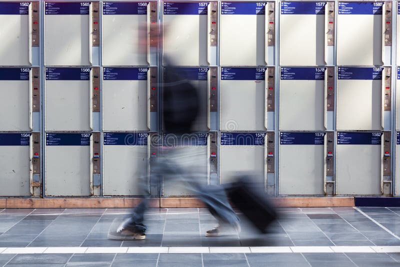 Blurred Person Walks in Front of Left Luggage Lockers Stock Photo ...