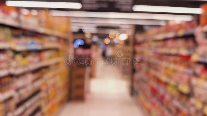 A Blurred Perspective Inside a Grocery Store Full of Products Stock ...