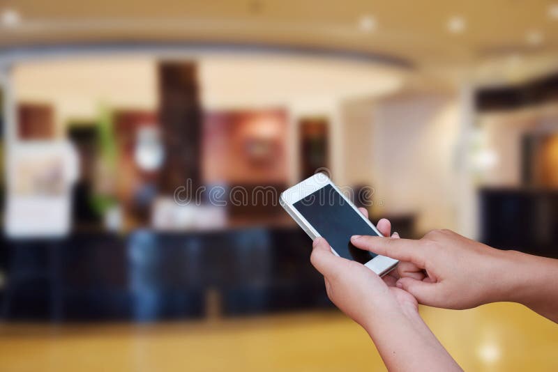 Blurred Photo and Smartphone on Hotel Lobby Background. Stock Photo ...