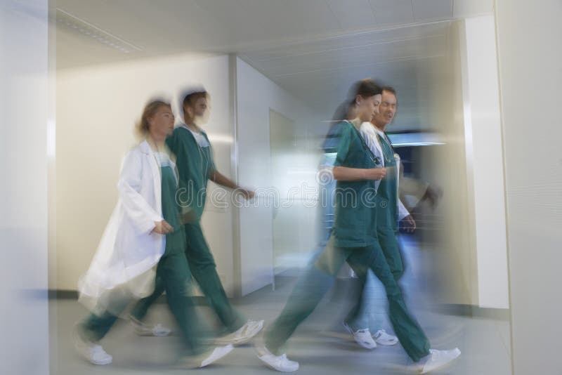 Blurred Physicians Rushing through Hospital Corridor Stock Photo ...
