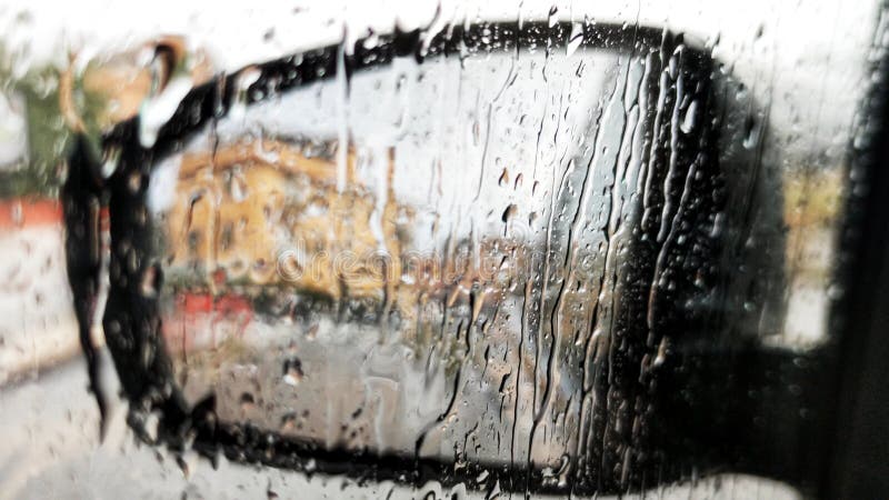 Blurred,Rain Drops on a Car Window with the Mirror in the Background ...