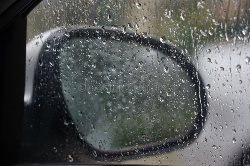 Blurred,Rain Drops on a Car Window with the Mirror in the Background ...