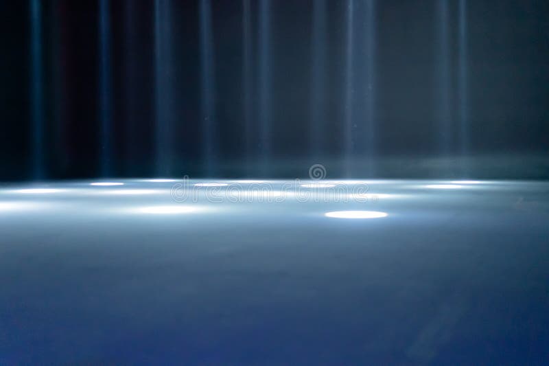 Blurred Rays of Light on Disco Floor. White Blue Neon Searchlight ...