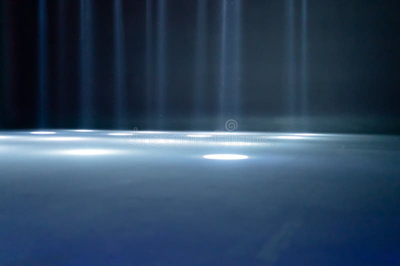 Blurred Rays of Light on Disco Floor. White Blue Neon Searchlight ...