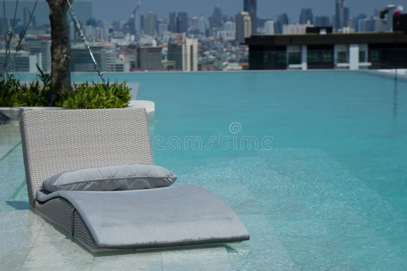 Relaxing Pool Bed beside Swimming Pool Stock Image - Image of lounge ...