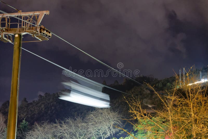 Blurred View of Moving White Cablecar at Night Stock Image - Image of ...
