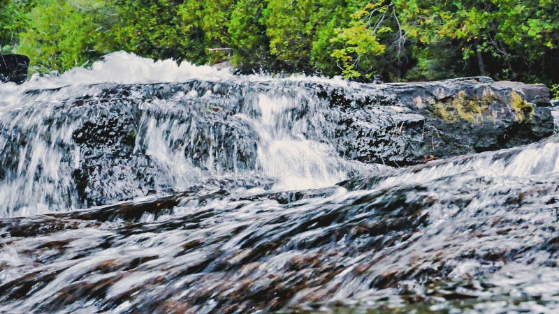 Blurry cascade over rocks stock image. Image of rapid - 375588761