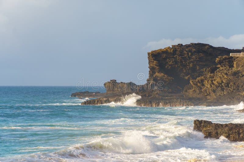 A Blurry Image of a Beach with Waves Crashing on Rocks Under the Sky ...
