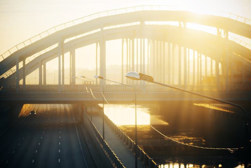 A Blurry Image of a Bridge Over a River, through Which the Sun`s Rays ...