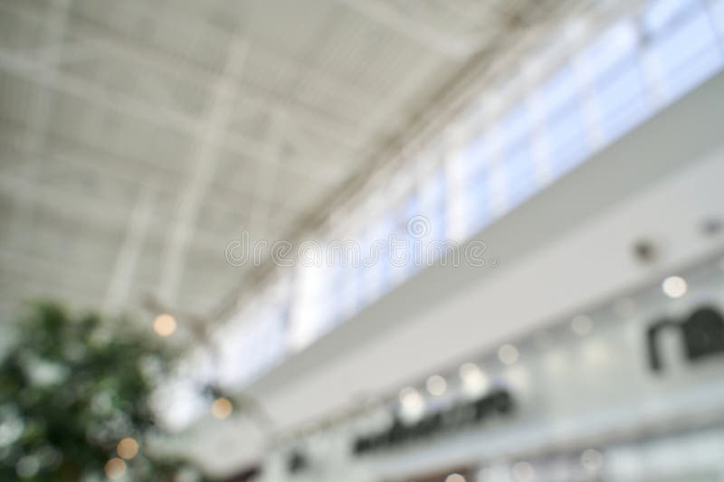 Blurry Interior View of a Modern Shopping Mall with High Ceilings and ...