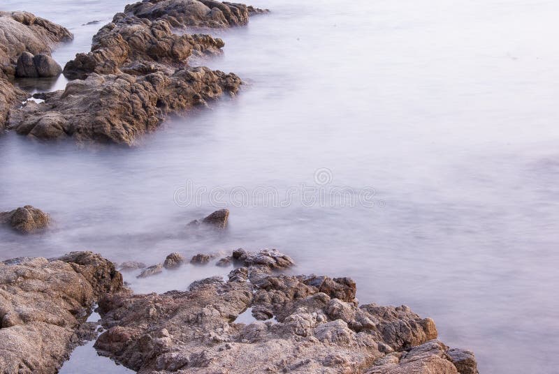 Blurry ocean between rocks stock photo. Image of cliffs - 41689418
