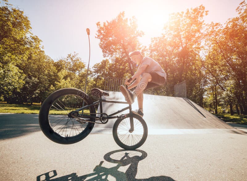 Bmx Rider Performing Tricks at Skatepark. Background. Stock Photo ...