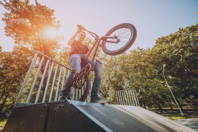 Bmx Rider Performing Tricks at Skatepark. Background. Stock Photo ...