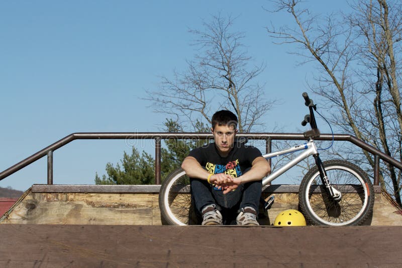 Bmx Rider Sitting At Skate Park Stock Photo - Image of stare, skatepark ...