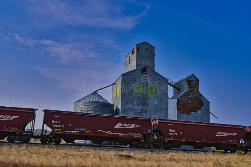 Bnsf Rail Cars Race Along the Tracks in Front of an Old Grain Elevator ...