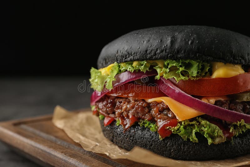 Board with Black Burger on Dark Background, Closeup Stock Photo - Image ...
