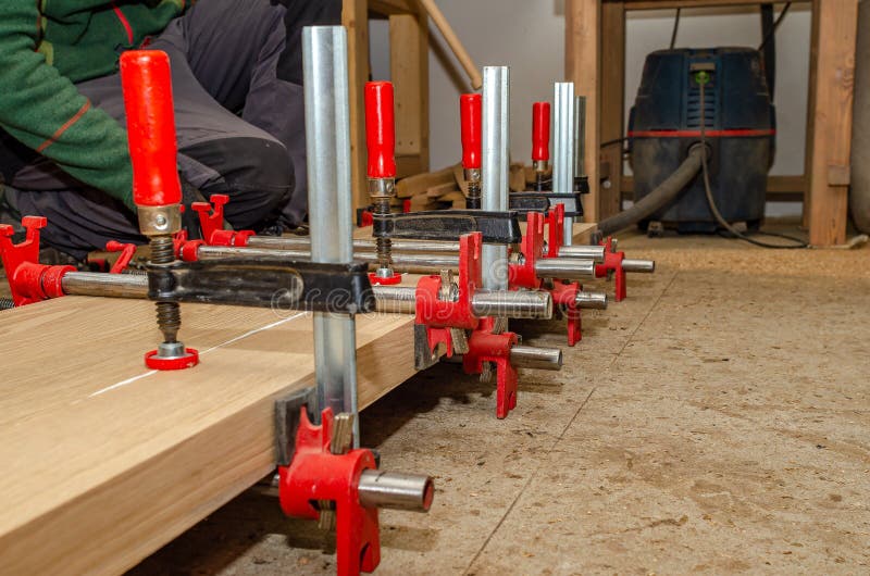 Board with Clamps in a Carpentry Workshop. Joinery Work. Carpenter ...