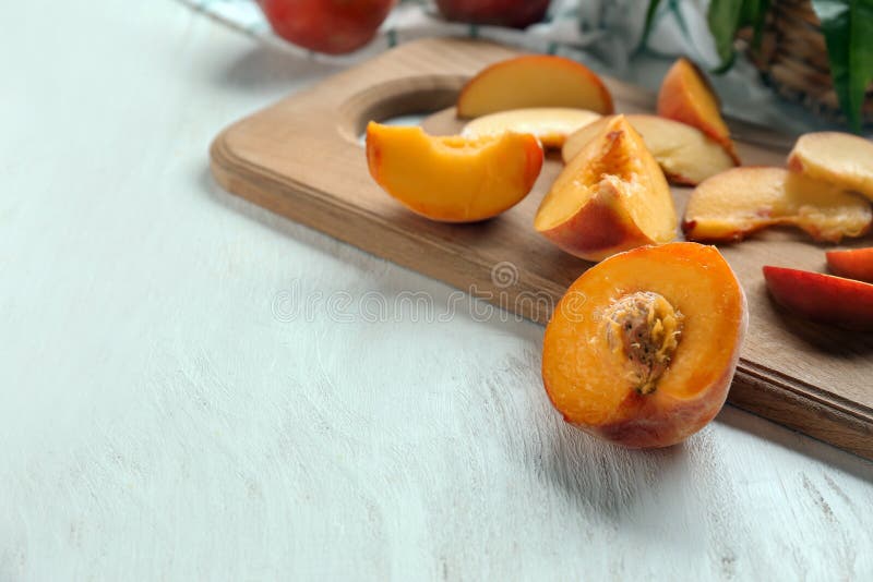 Board with Fresh Cut Peaches on White Wooden Table Stock Image - Image ...
