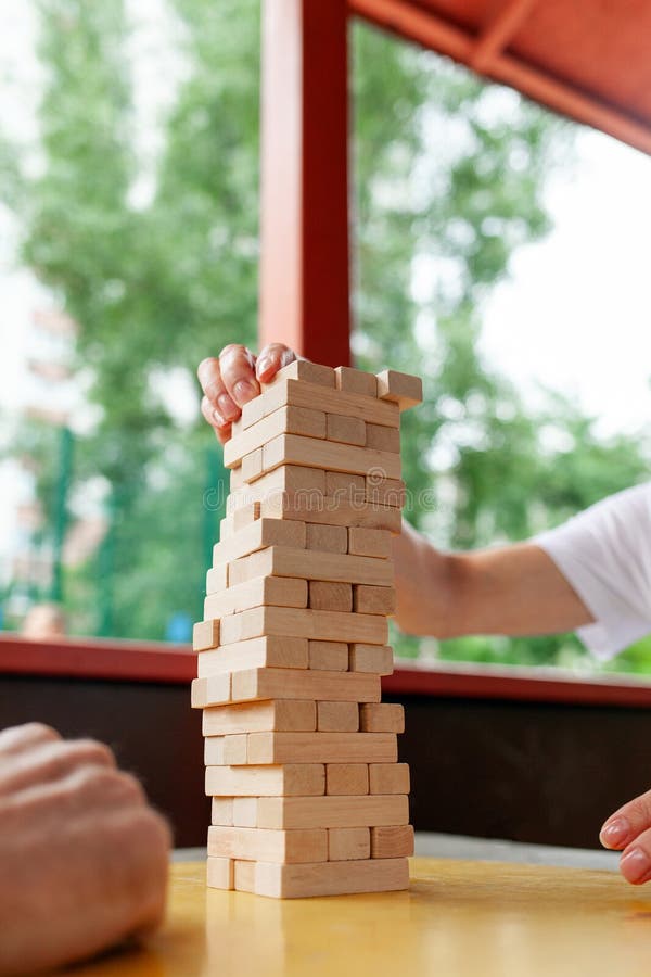 Board Game, Hand Builds Tower from Wooden Bricks Stock Image - Image of ...