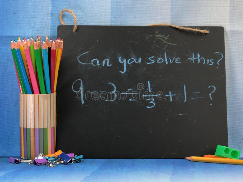 A Board with Mathematical Examples and a Teacher at the Table Stock ...