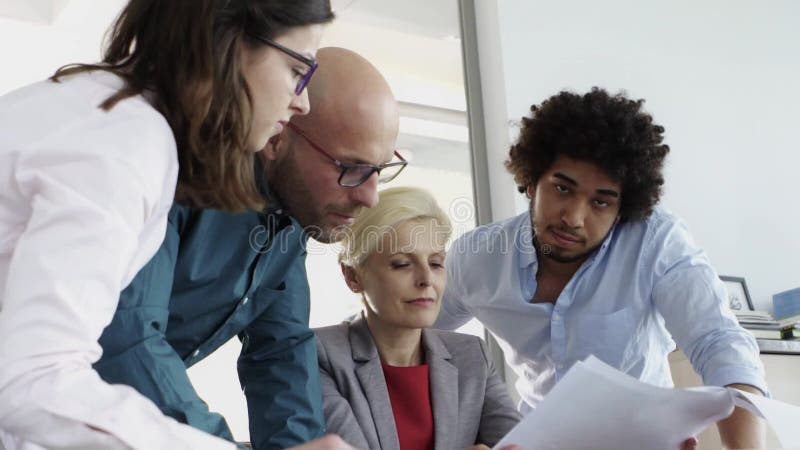 Four Staff Members Talking during Group Briefing in Meeting Room Stock ...