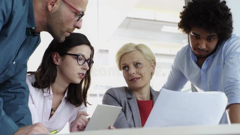 Four Staff Members Talking during Group Briefing in Meeting Room Stock ...