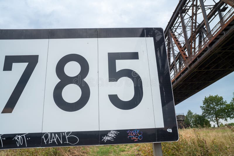 Board with a Number 785 Under a Bridge Stock Image - Image of grass ...