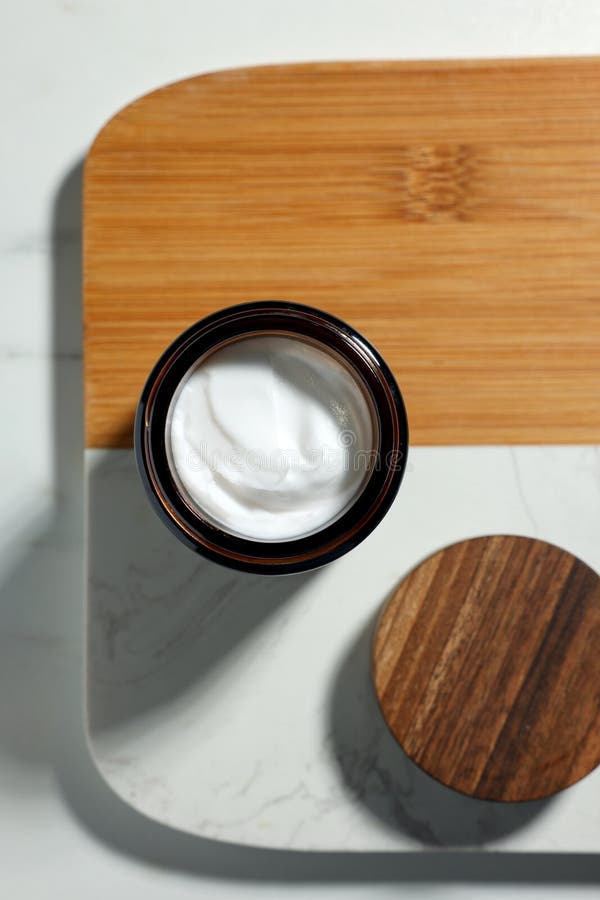 Board with Open Jar of Cosmetic Cream on White Table, Top View Stock ...