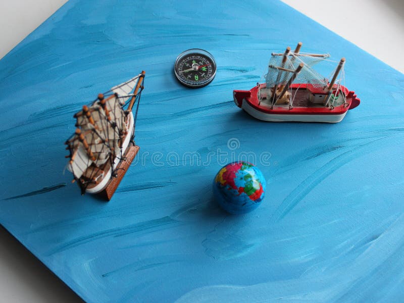 A Board Painted with an Ocean Pattern with Models of Sailing Ships, a ...