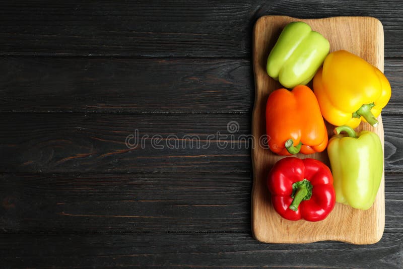 Board with Ripe Bell Peppers on Black Table, Top View Stock Image ...