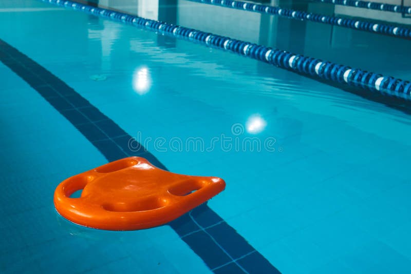 A Board with Swimming Handles Lies on the Surface of the Water in the ...