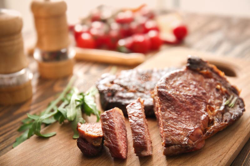 Board with Tasty Cut Grilled Meat on Table Stock Image - Image of meat ...