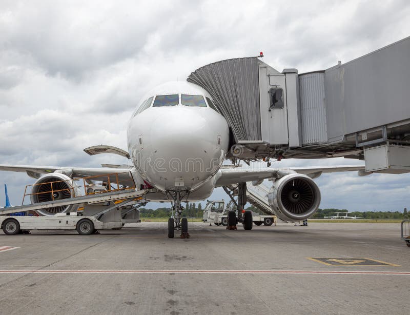 Boarding Passengers on the Plane through the Boarding Bridge. the Plane ...