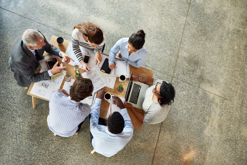 In the Boardroom...High Angle Shot of a Group of Coworkers Sitting ...