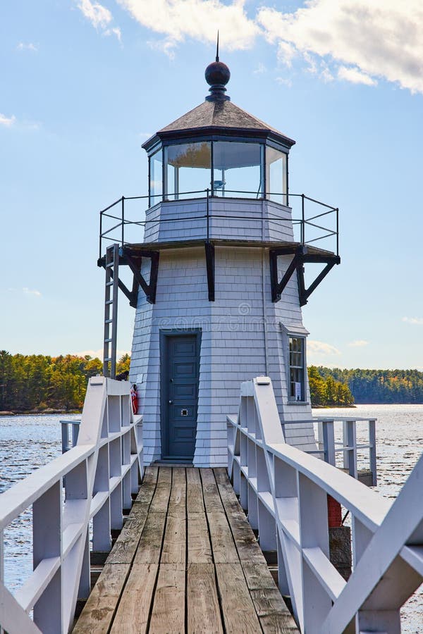 Boardwalk with Railing Leads To Small White Lighthouse on Maine River ...