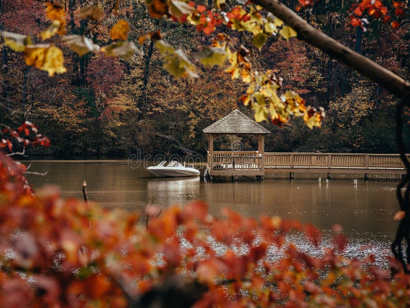 Boast at the Dock on a Lake in the Foliage Stock Image - Image of boat ...