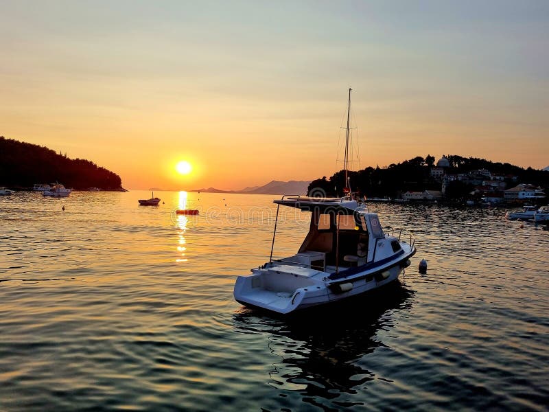 Boat Anchored in Sunlit Bay Stock Image - Image of sunlit, boat: 298035031
