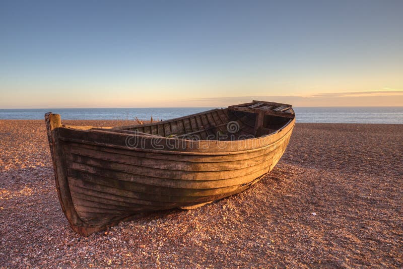 Boat on beach by sunset stock image. Image of cloud, orange - 18246385