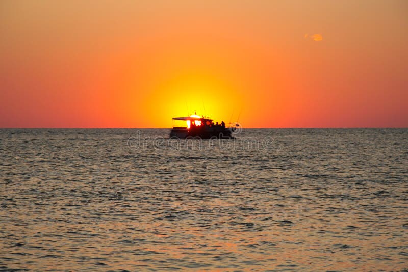 A Boat Carries the Sun at the Sunset Stock Photo - Image of sunset ...